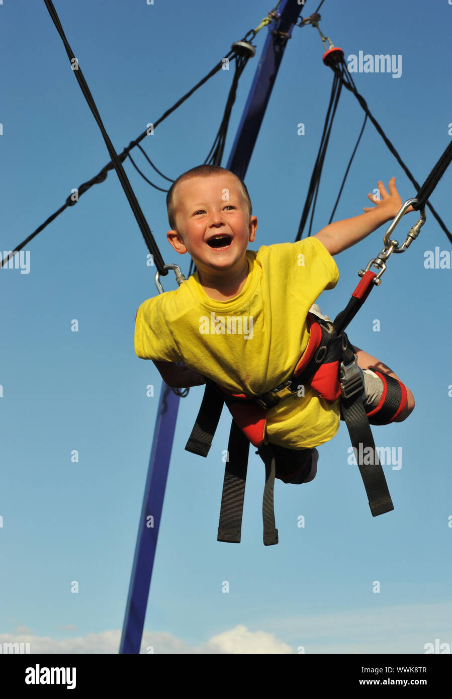 Little boy jumping on the trampoline (bungee jumping Stock Photo - Alamy