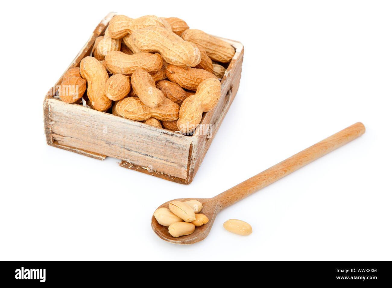 Peanuts in the old box, on white background Stock Photo - Alamy