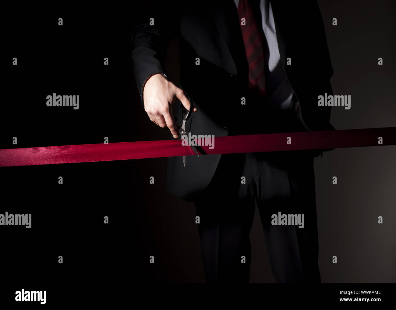 man in a suit, cuts a red tape, opening of event Stock Photo - Alamy