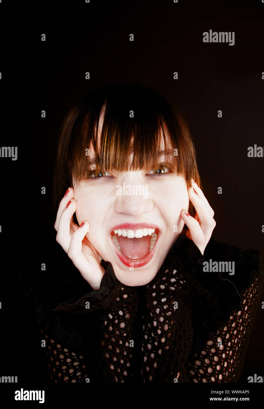 Young Girl with Hands to her face Screaming Stock Photo - Alamy