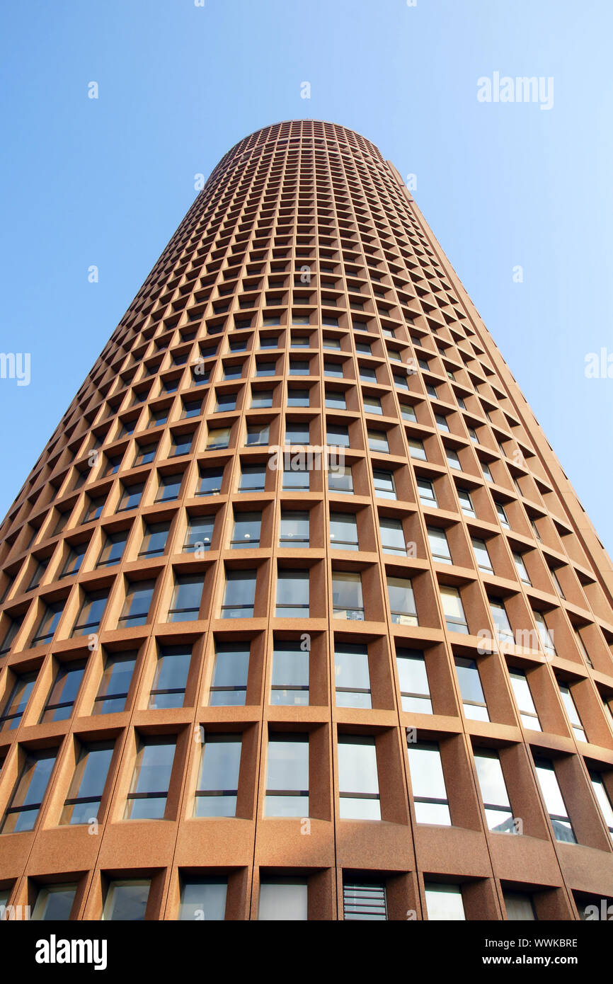 Architecture: perspective shot of a modern circular high rise tower ...