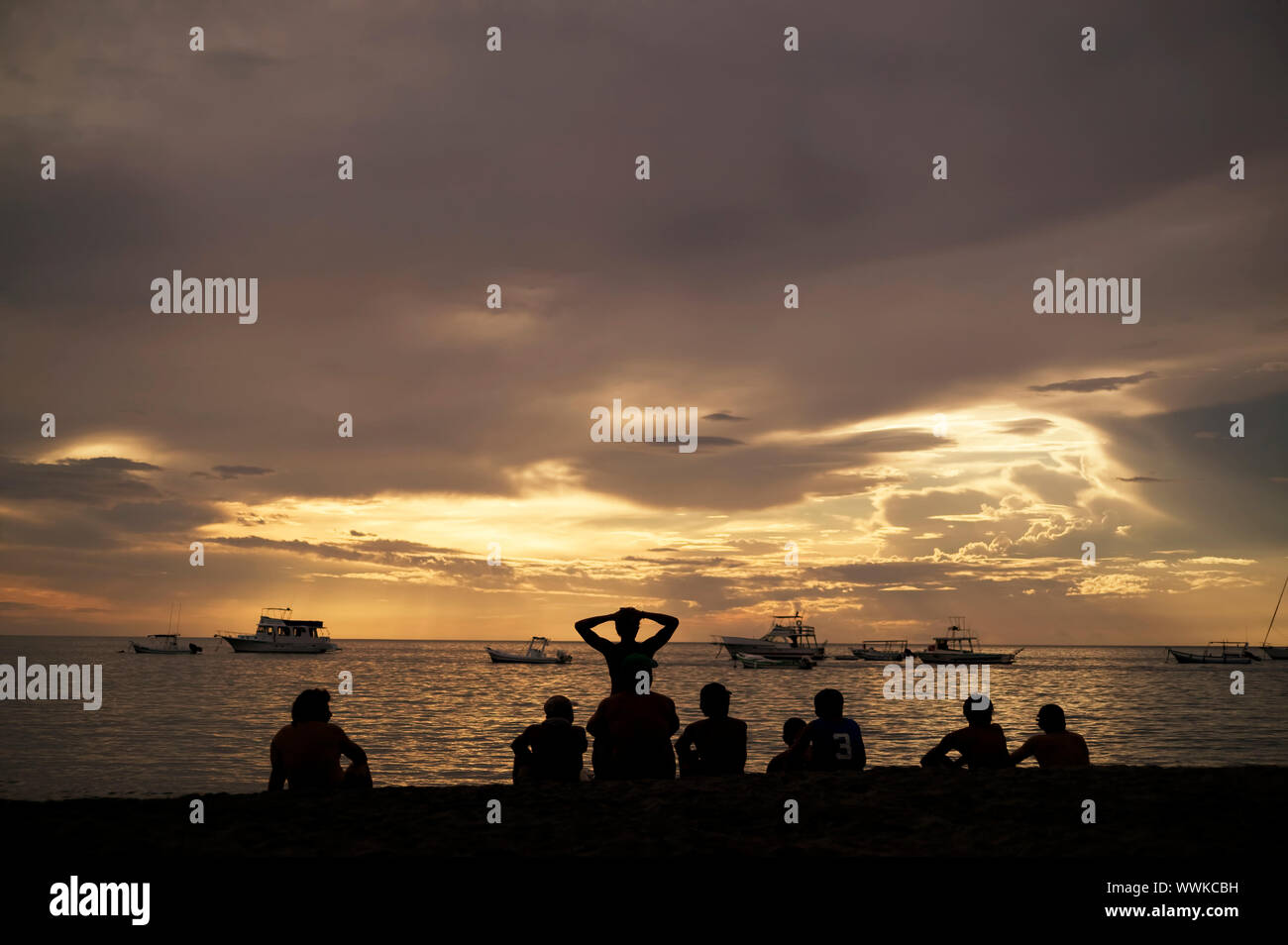 Costa Rica sunset with Boats and silhouettes of people on beach Stock ...