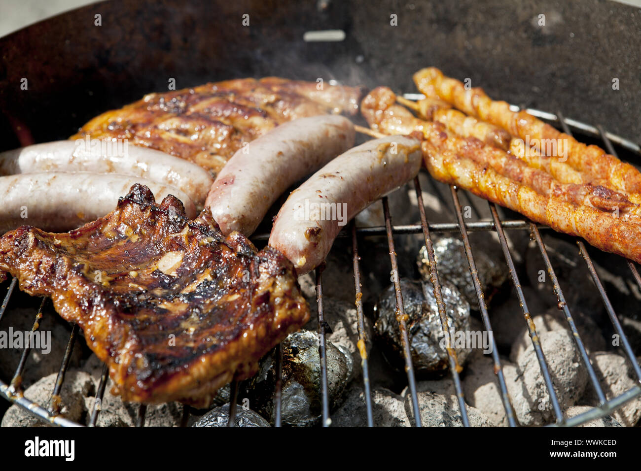 Fresh meat on a grill in summer in the open air Stock Photo - Alamy
