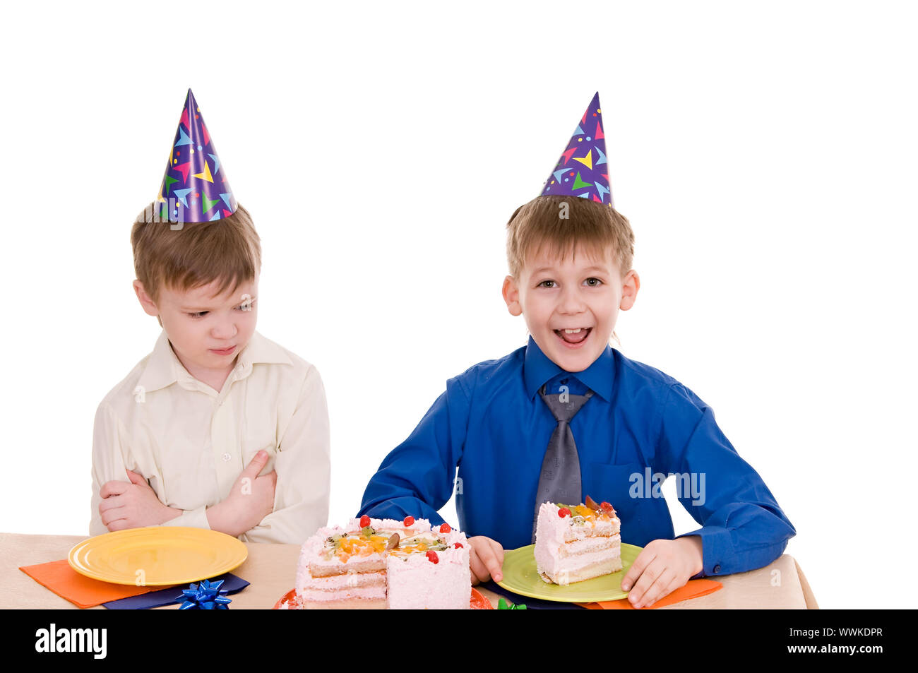 two boys eating a cake isolated on white background Stock Photo - Alamy