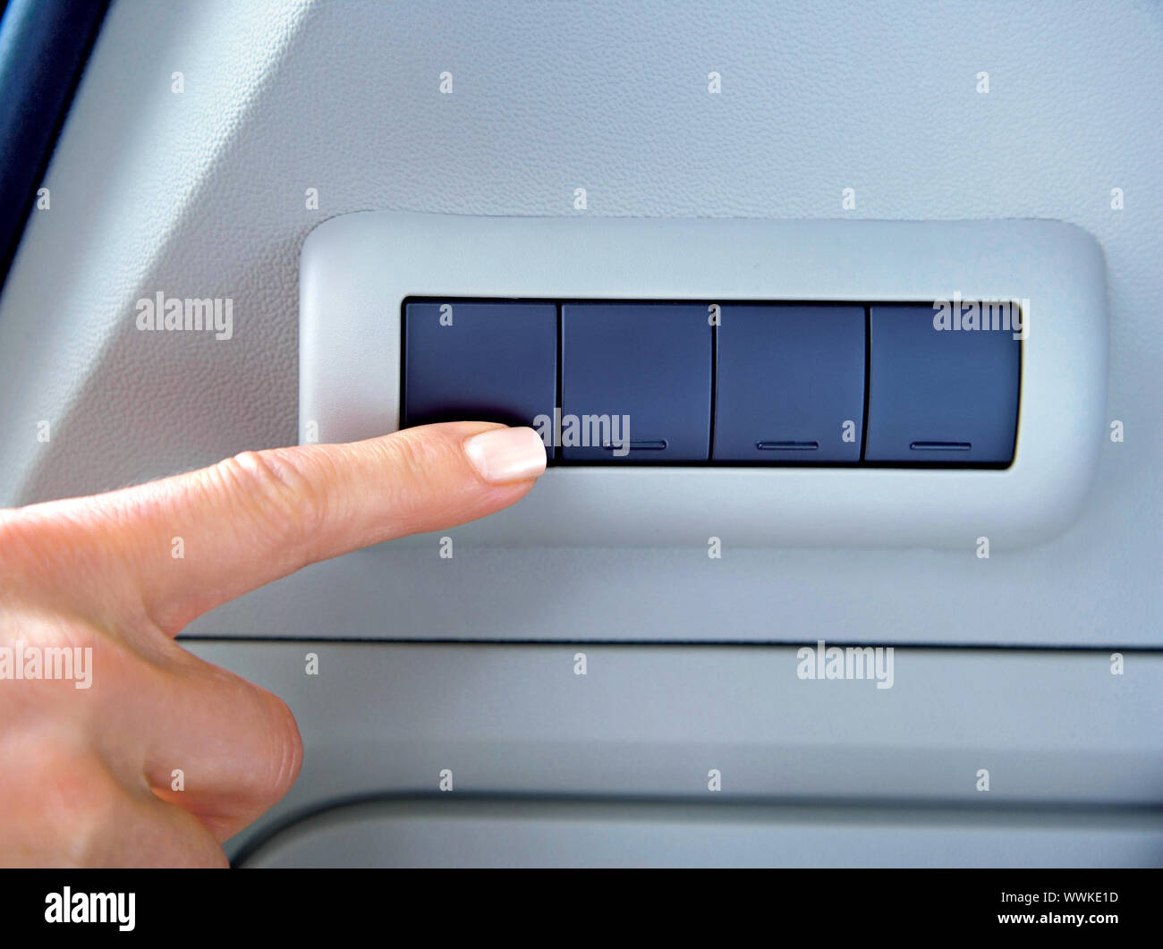 finger on buttons of device in a car Stock Photo - Alamy