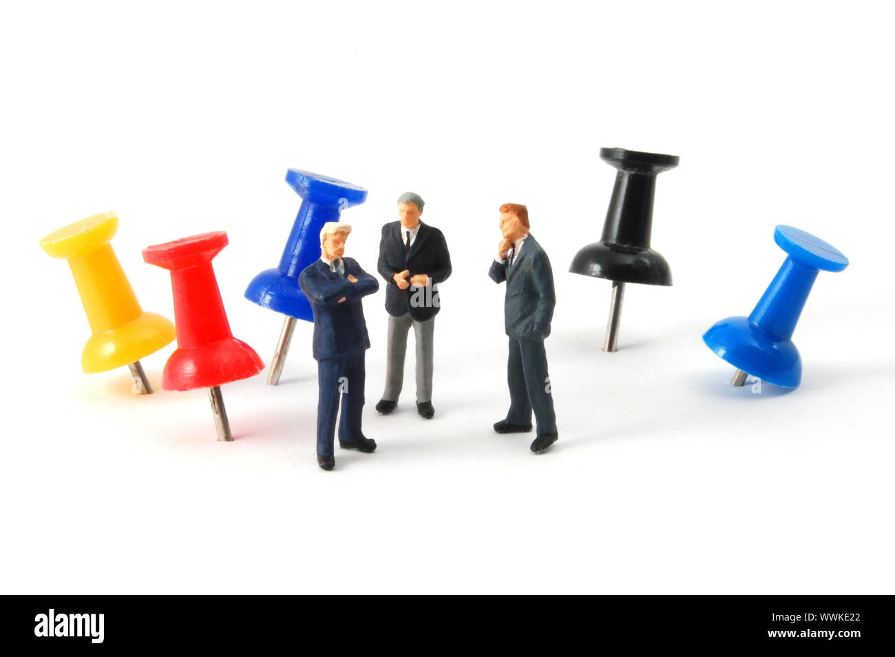 business man and push pin in a office isolated on white background ...