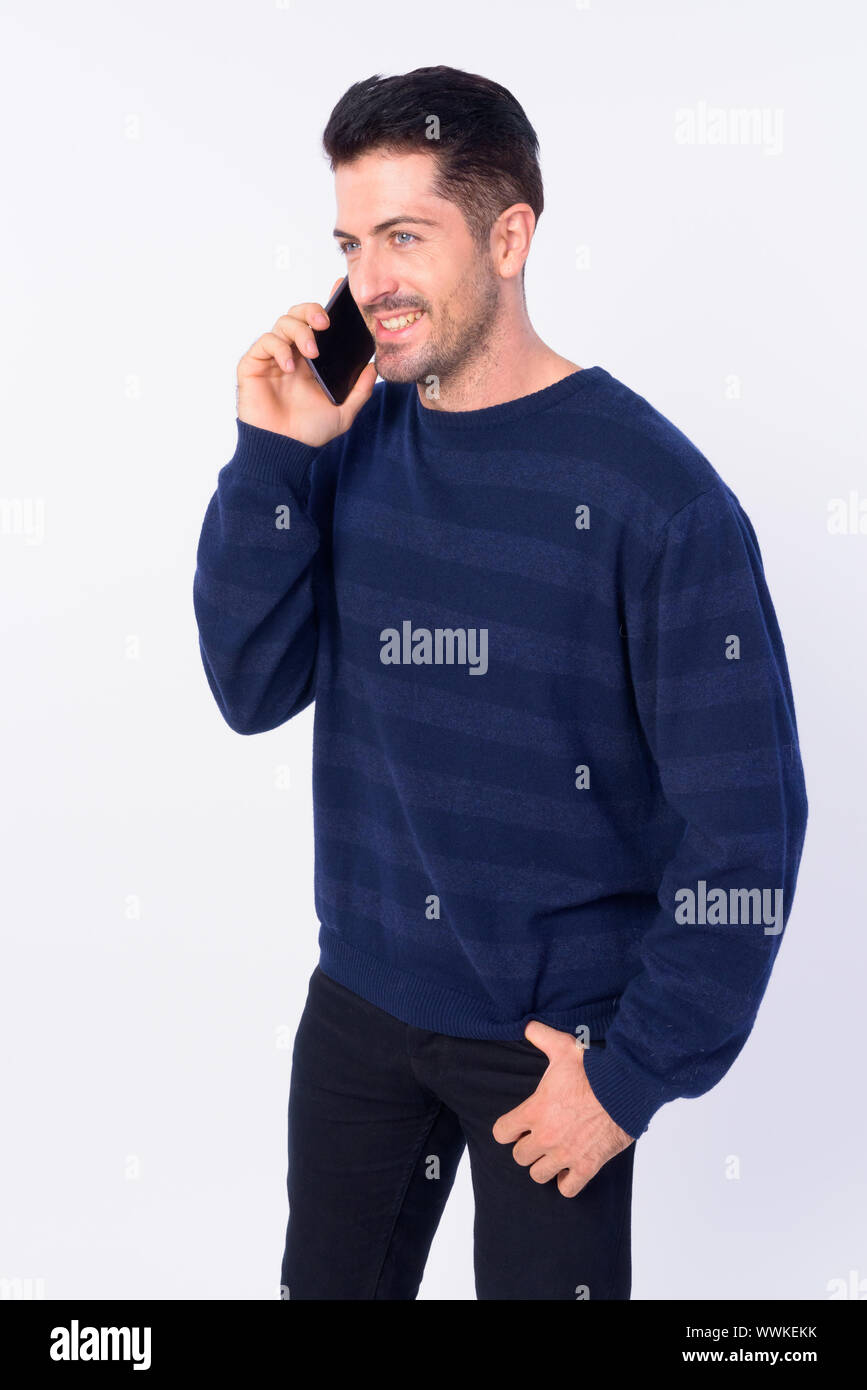 Portrait of happy bearded man thinking while talking on the phone Stock ...