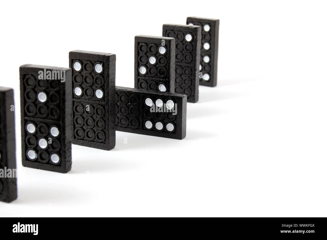 row of dominoes including a special domino stone isolated on white ...