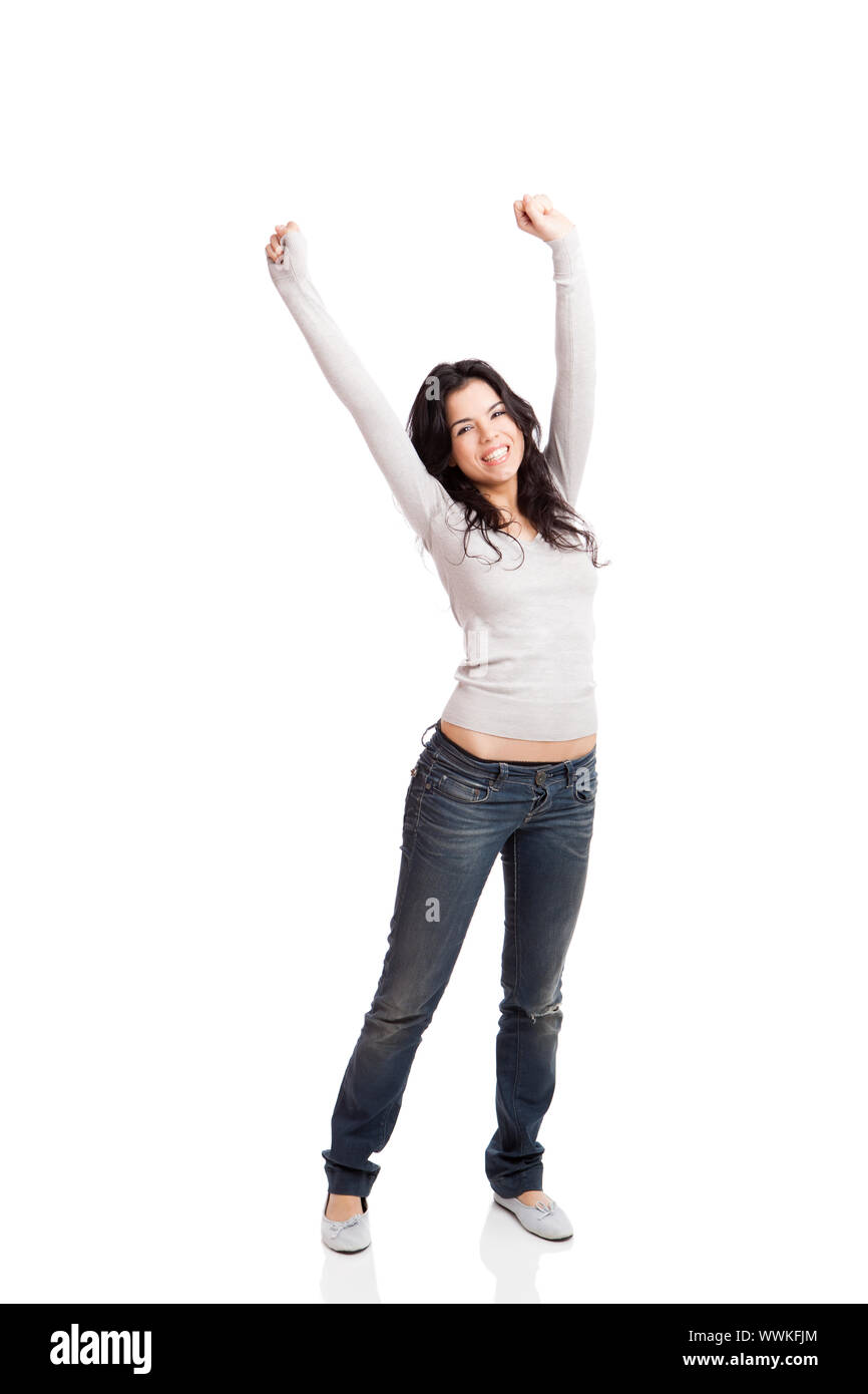 Happy young woman with arms up, isolated against a white background ...