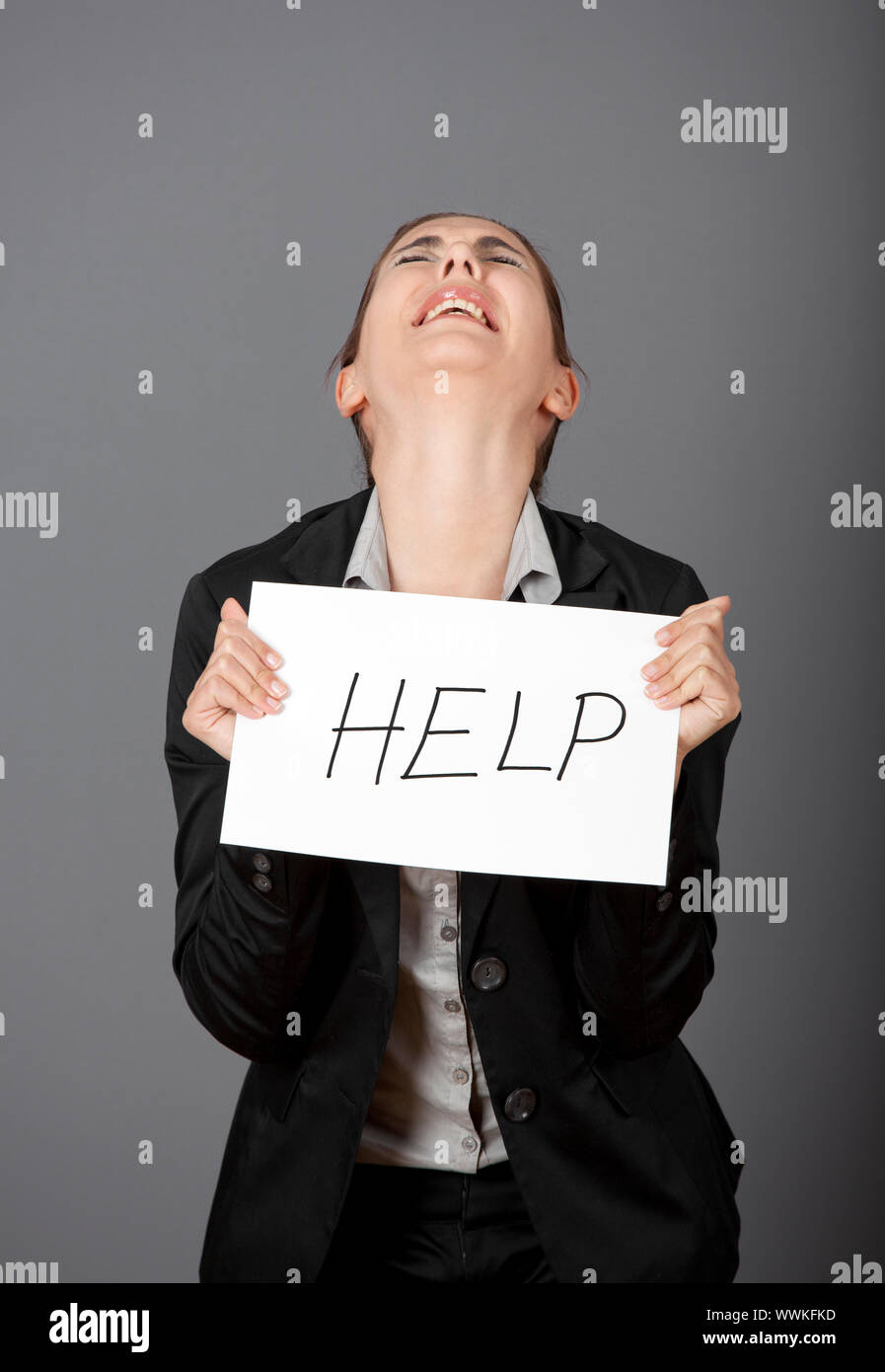 Stressed business woman imploring for help, holding a cardboard with ...