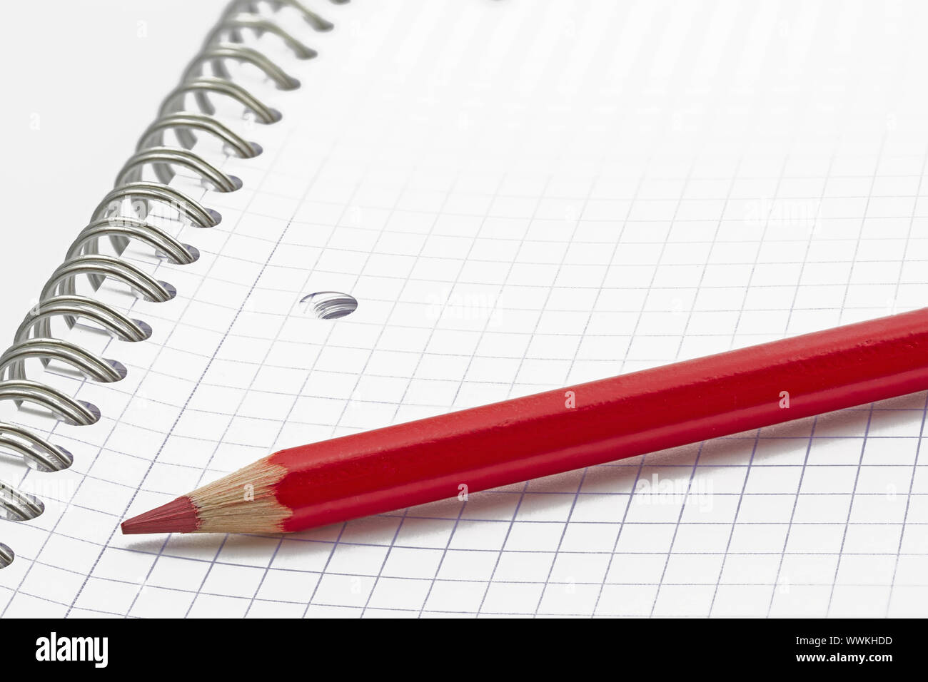 Red pencil on notepad Stock Photo - Alamy