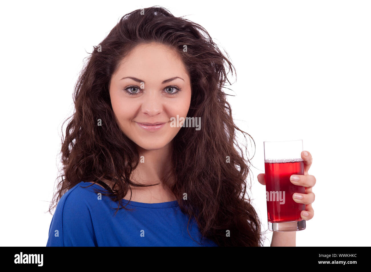 Young beautiful woman drinks red juice Stock Photo - Alamy