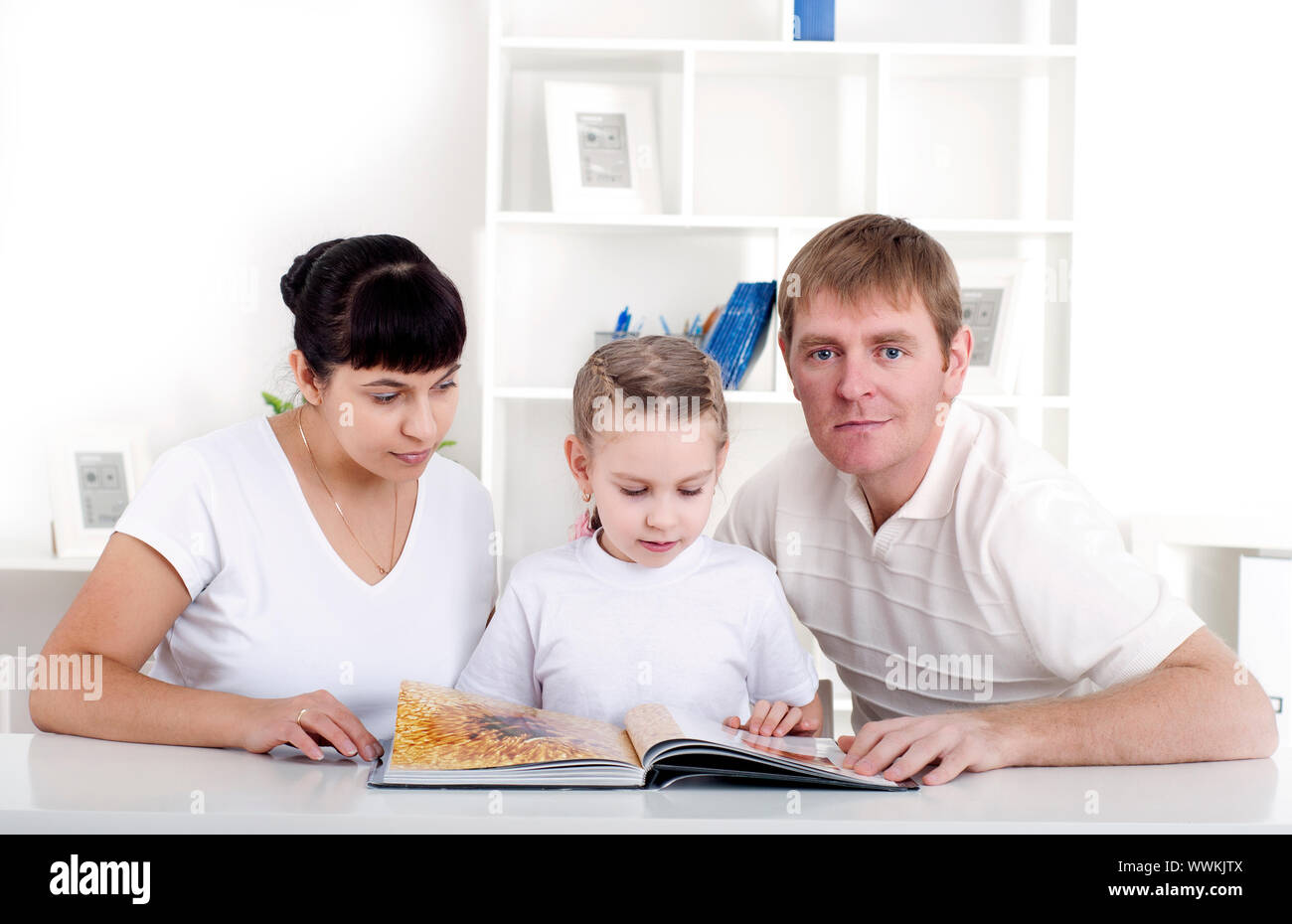 Family reading a book together, a family vacation Stock Photo - Alamy
