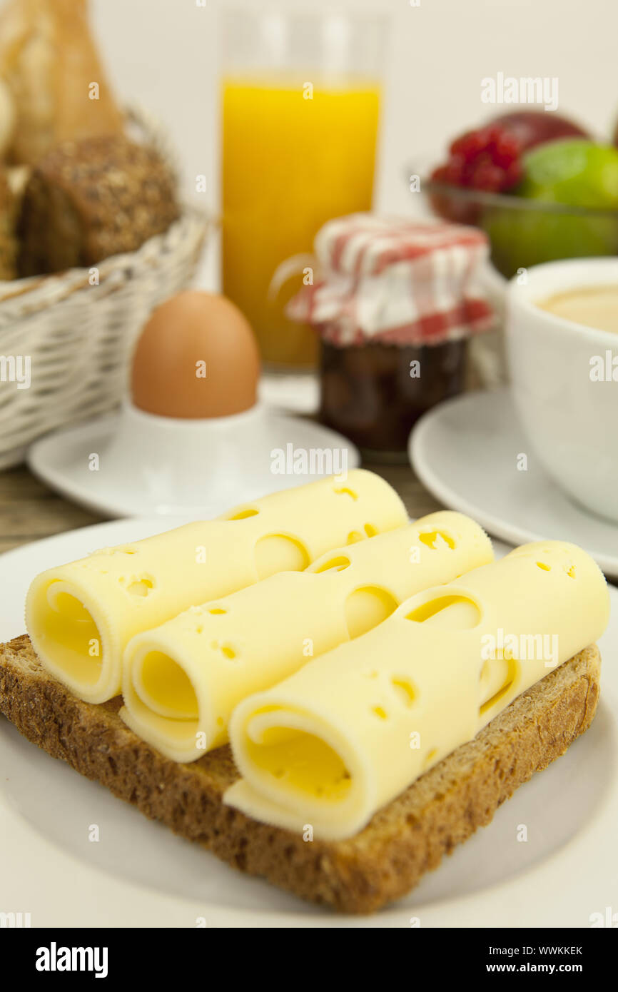 Breakfast with toast, cheese, egg and fruit on one table Stock Photo ...