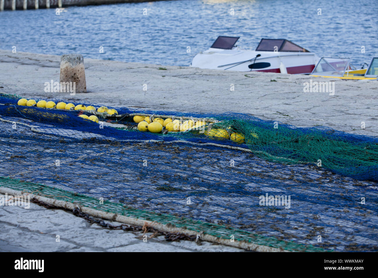 Fishing net with lines and ropes on the ship at the quay in the harbour ...