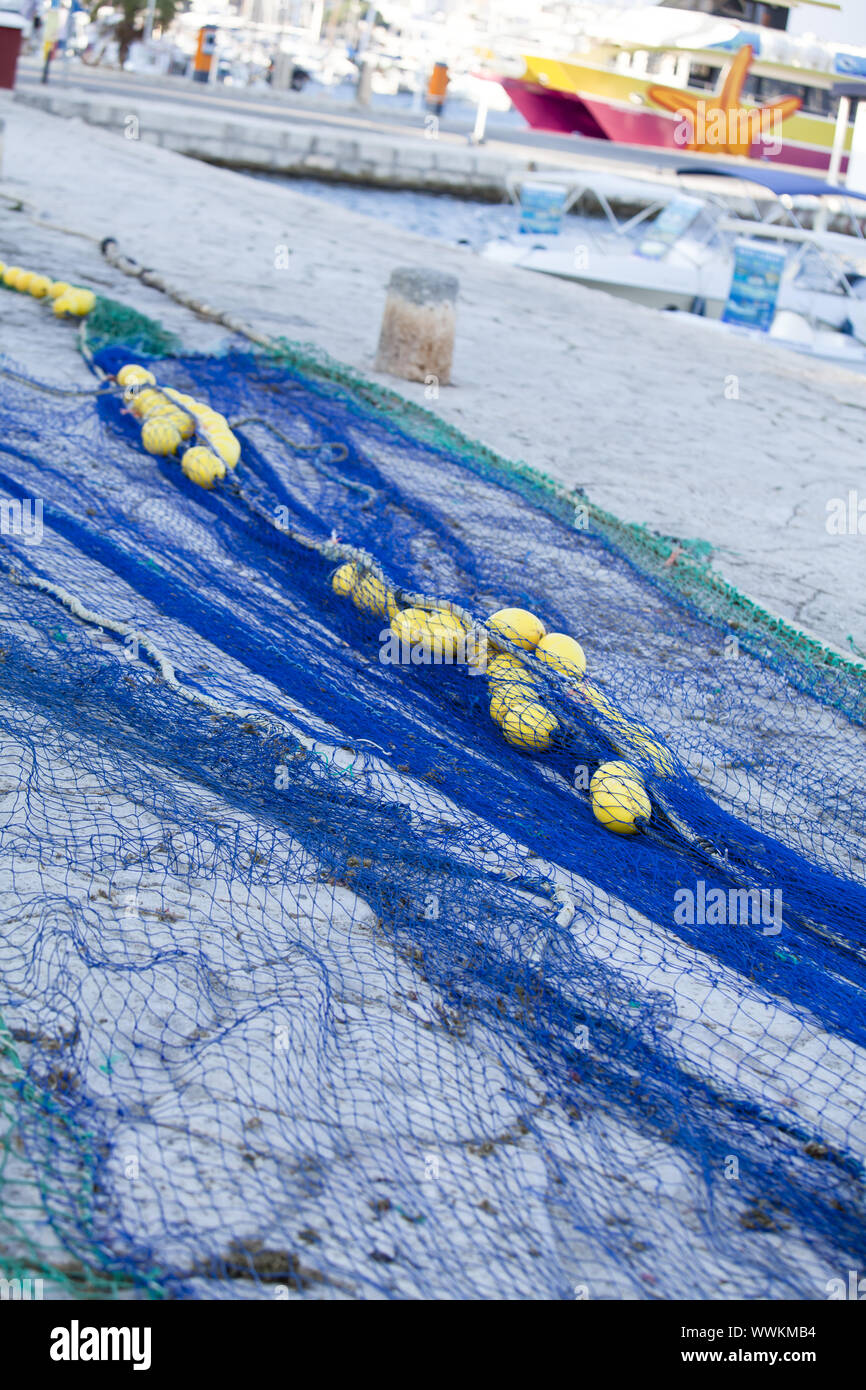 Fishing net with lines and ropes on the ship at the quay in the harbour ...