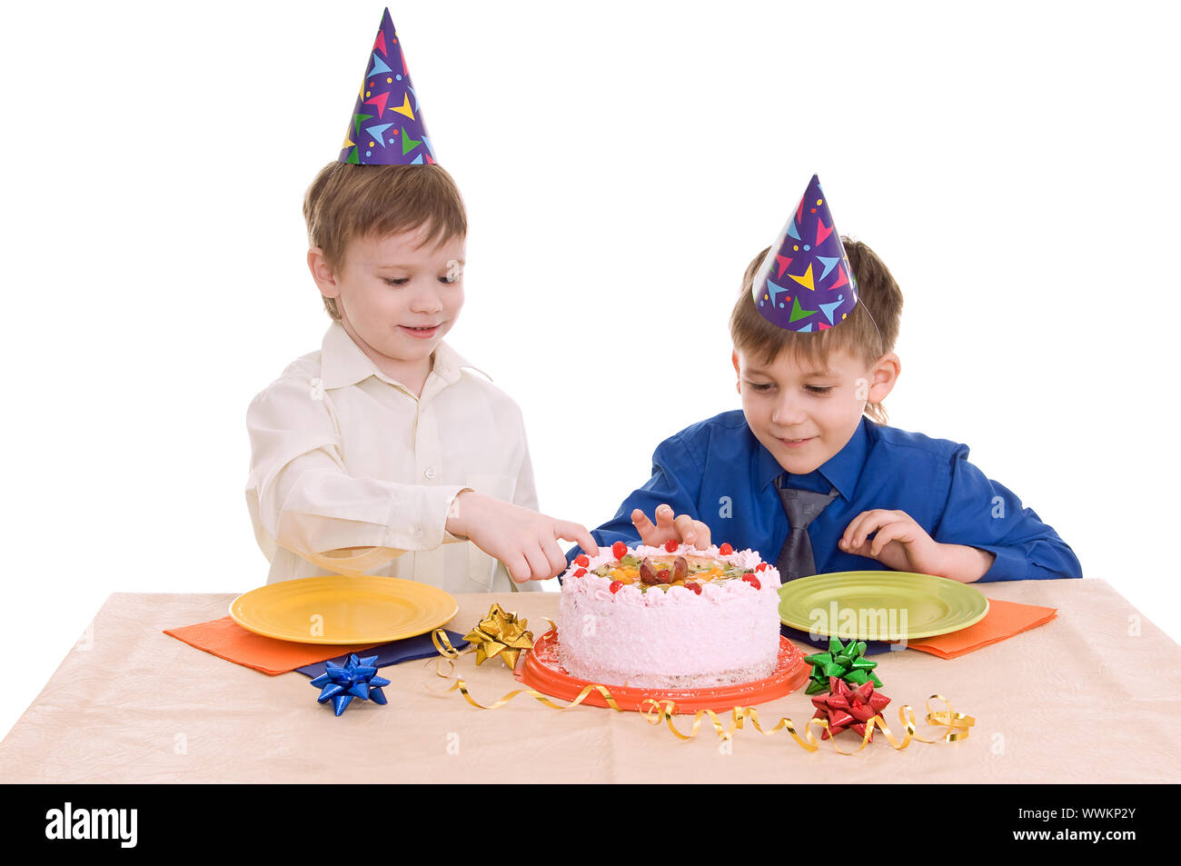 two boys eating a cake isolated on white background Stock Photo - Alamy