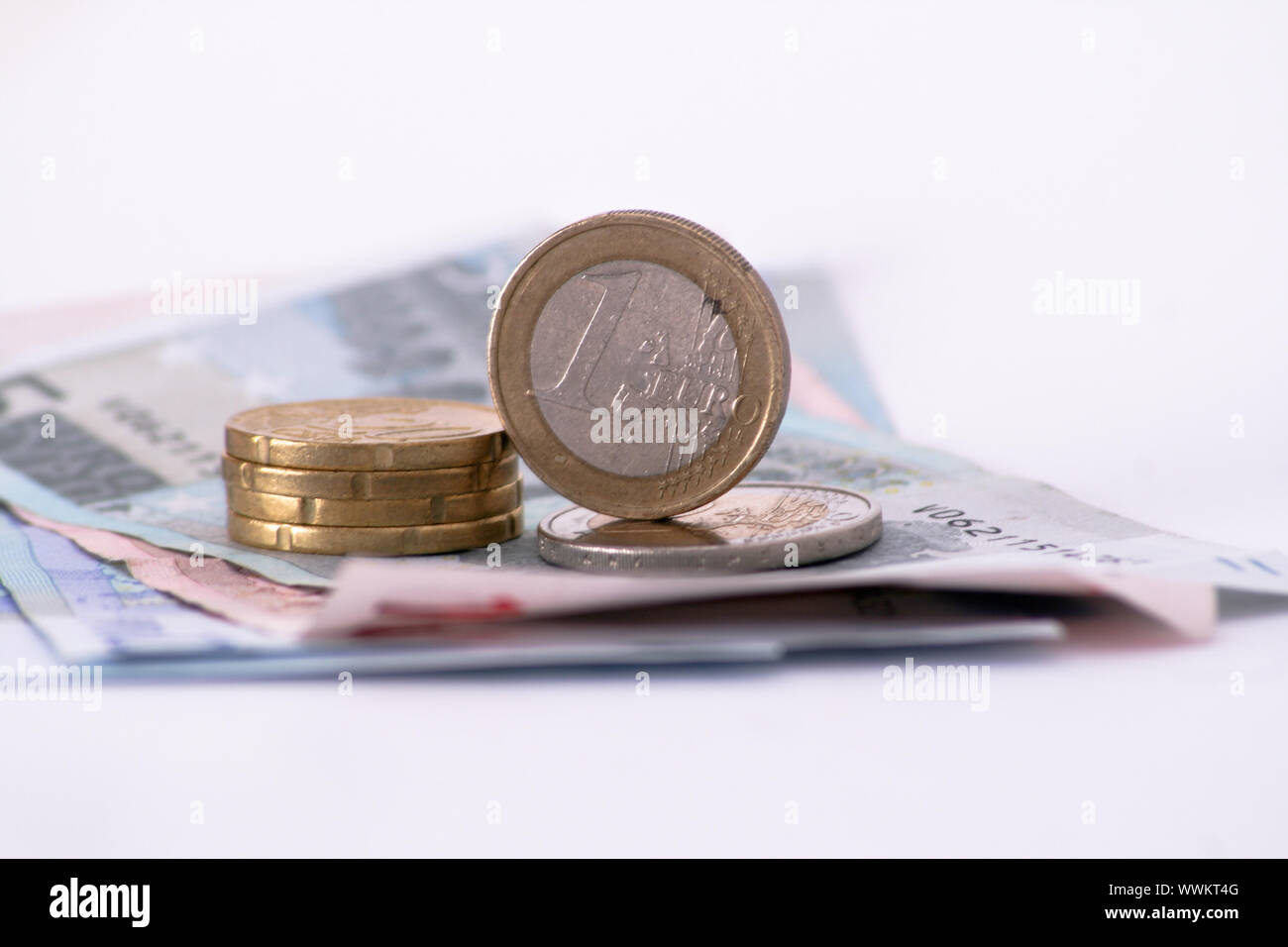 euro bills and coins at white background Stock Photo - Alamy