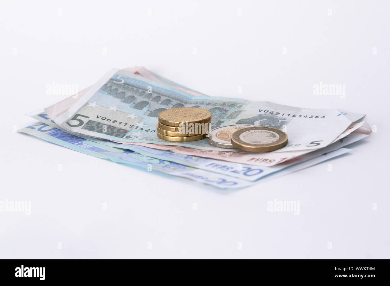euro bills and coins at white background Stock Photo - Alamy
