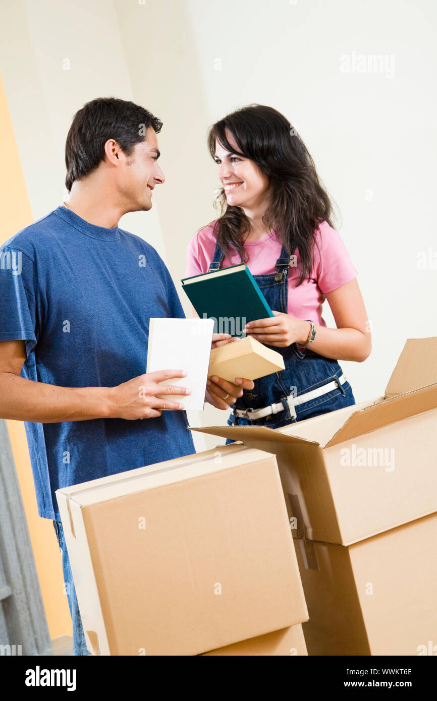 Young happy couple moving boxes at home Stock Photo - Alamy