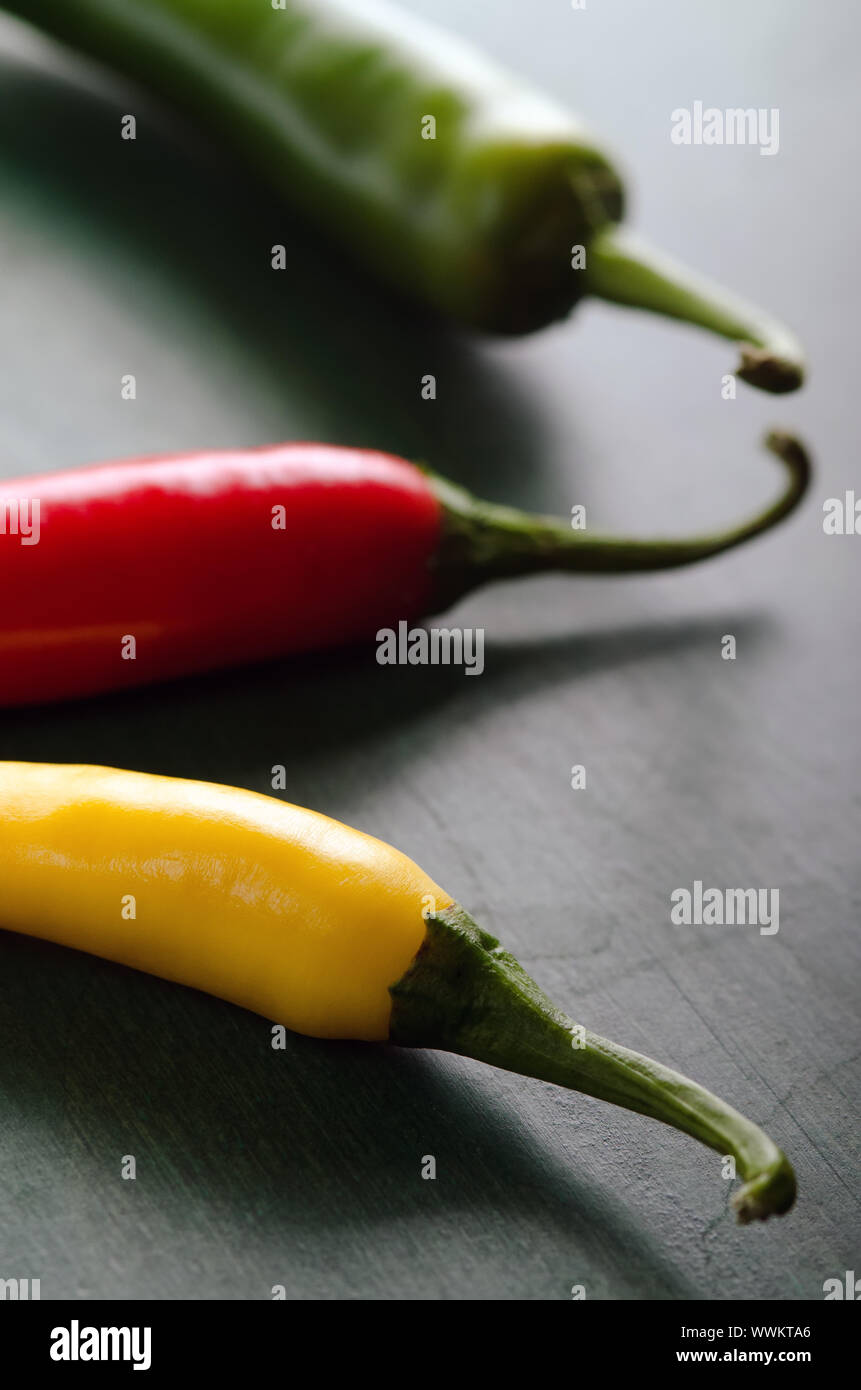 three colorful chillies Stock Photo - Alamy