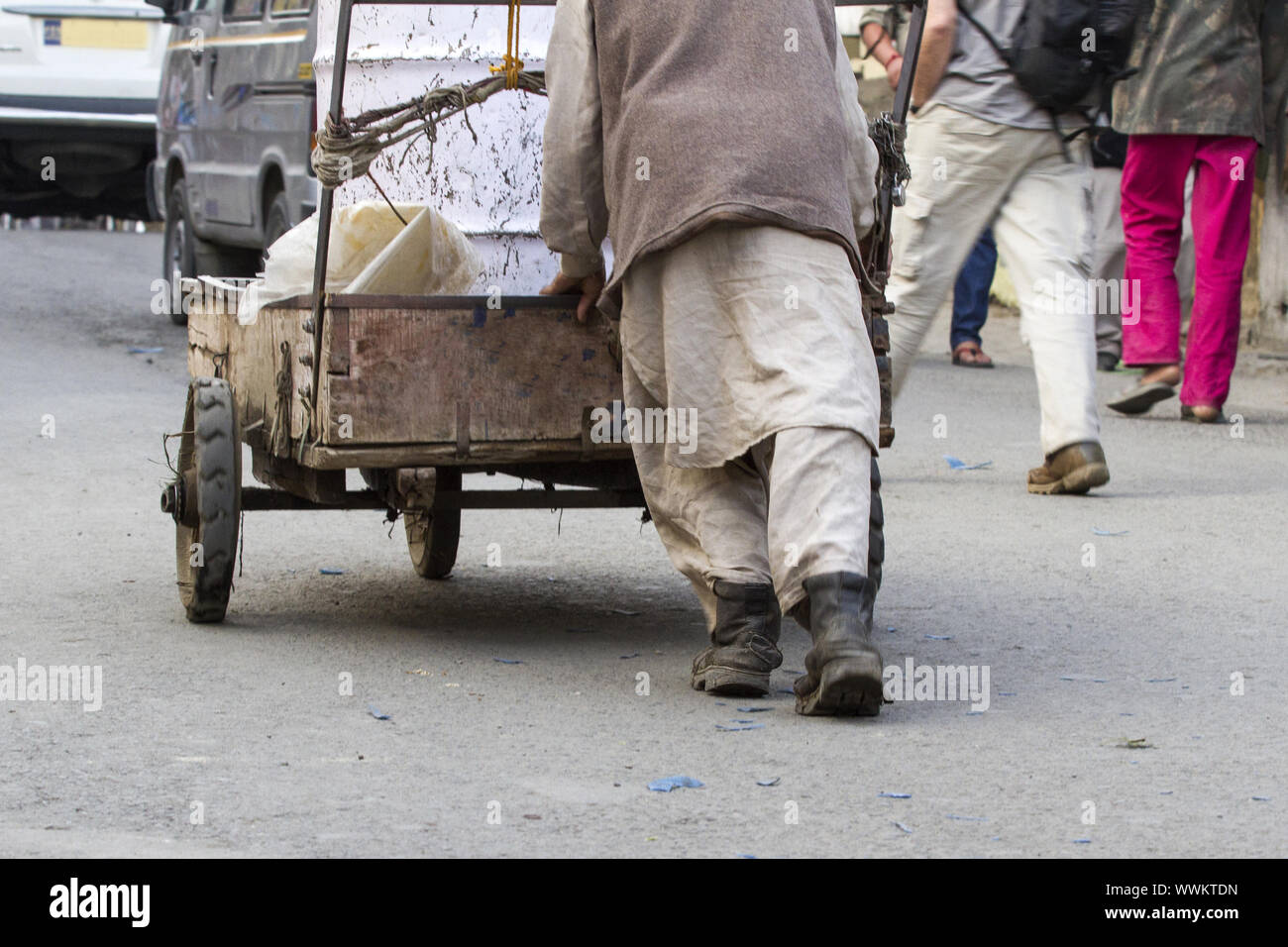 Old man pushing a wheelbarrow hi-res stock photography and images - Alamy