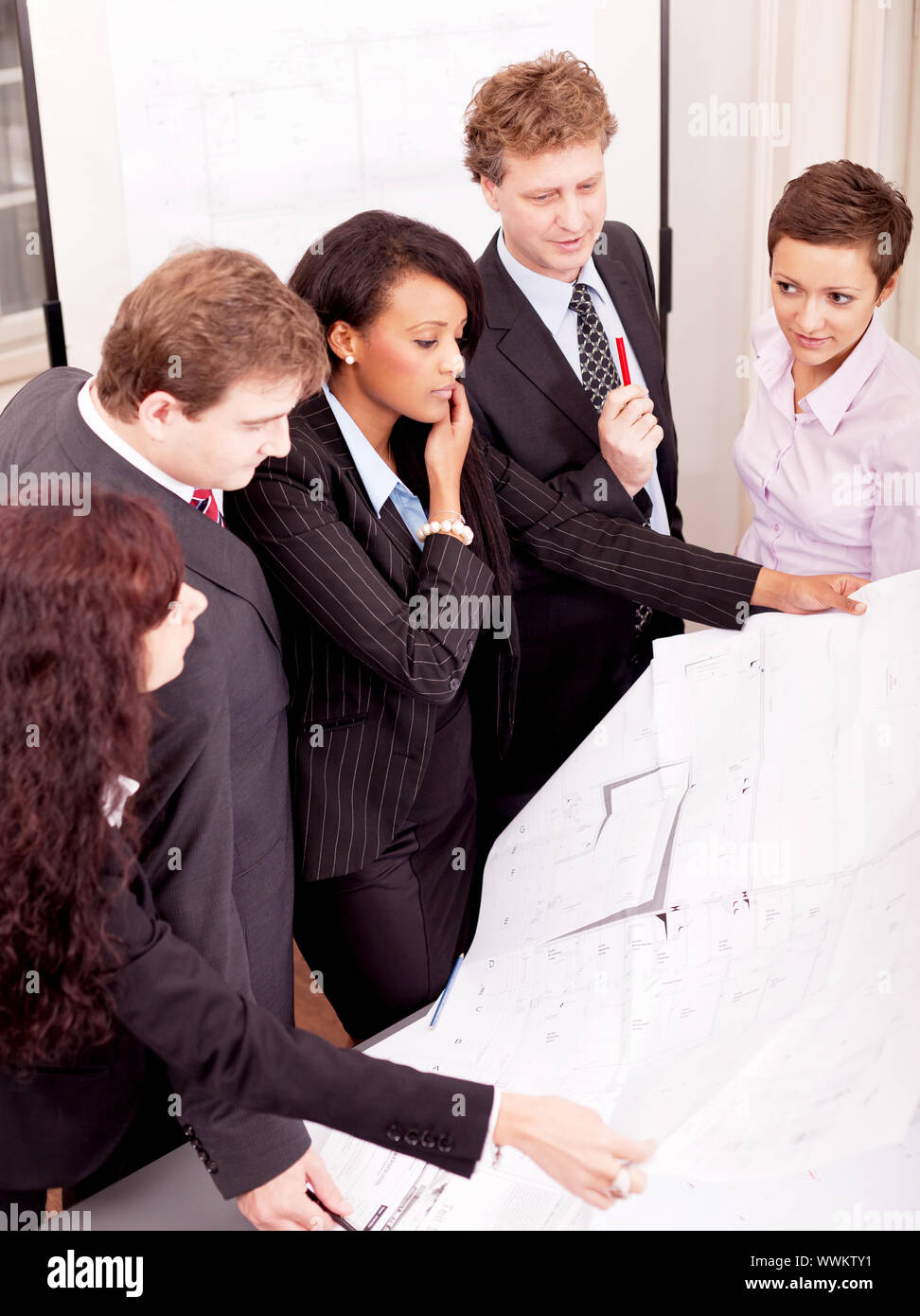 team group conference with architecture and construction plans Stock ...