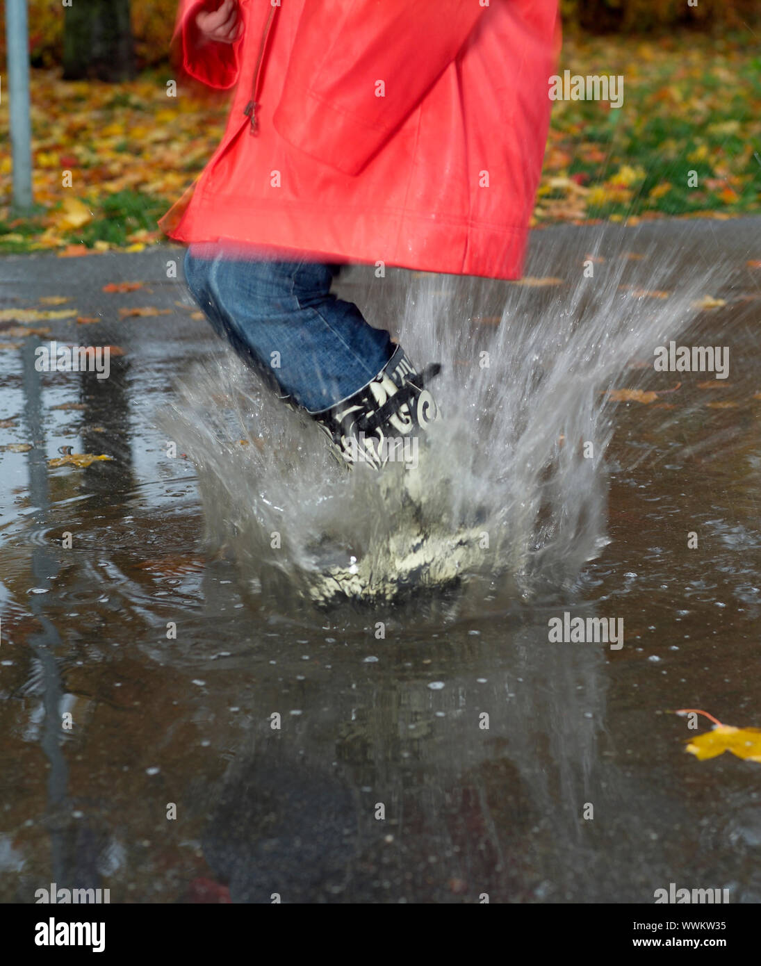 Woman jumping in a puddle hi-res stock photography and images - Alamy