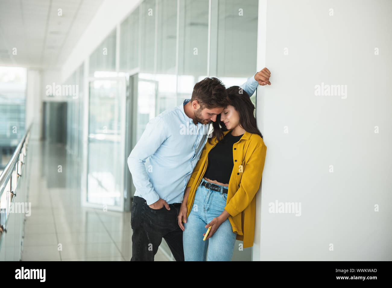 two young colleagues handsome man and beautiful woman flirting together ...