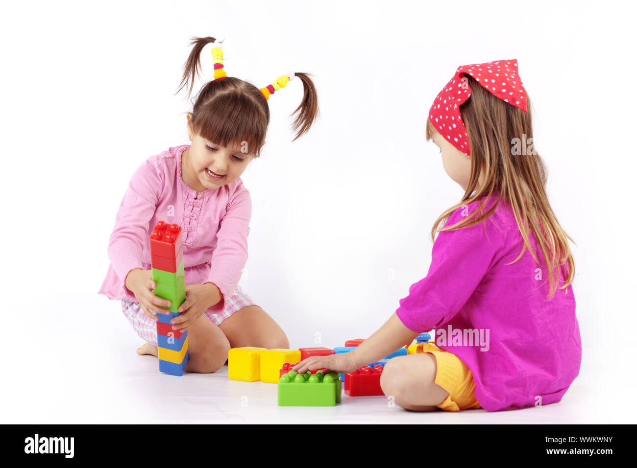 Portrait of two kids playing with constructor over white Stock Photo ...