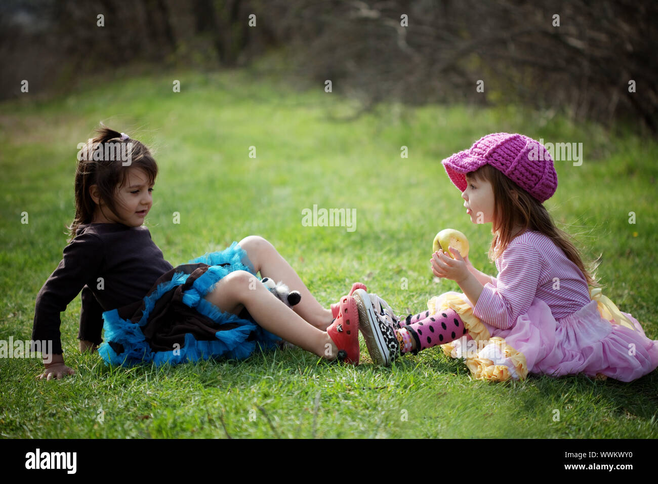 Two kid girls playing outdoors Stock Photo - Alamy