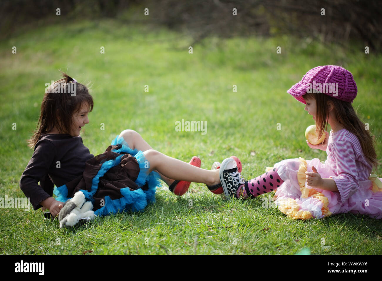 Two kid girls playing outdoors Stock Photo - Alamy