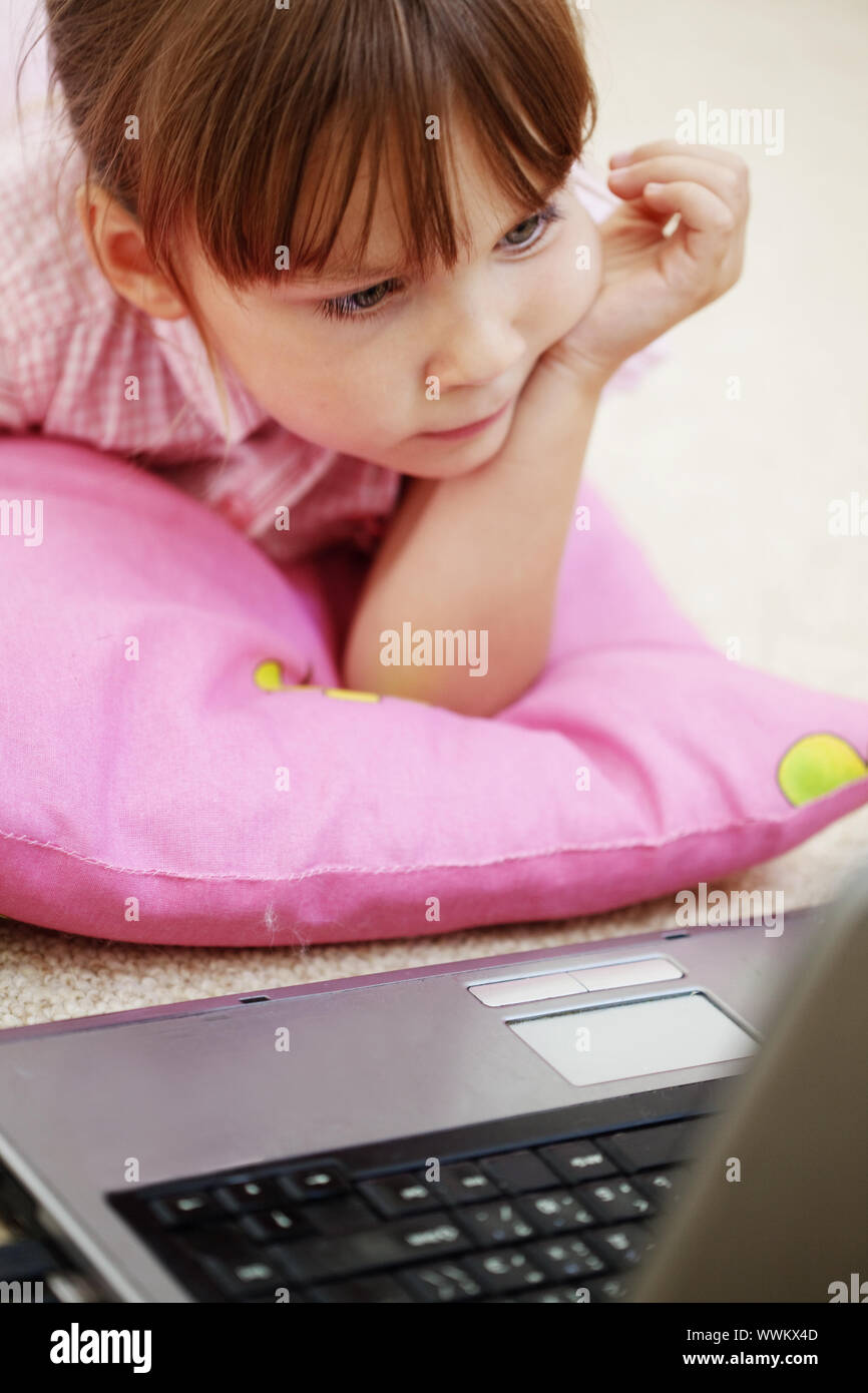 Little cute child working with laptop at home Stock Photo - Alamy