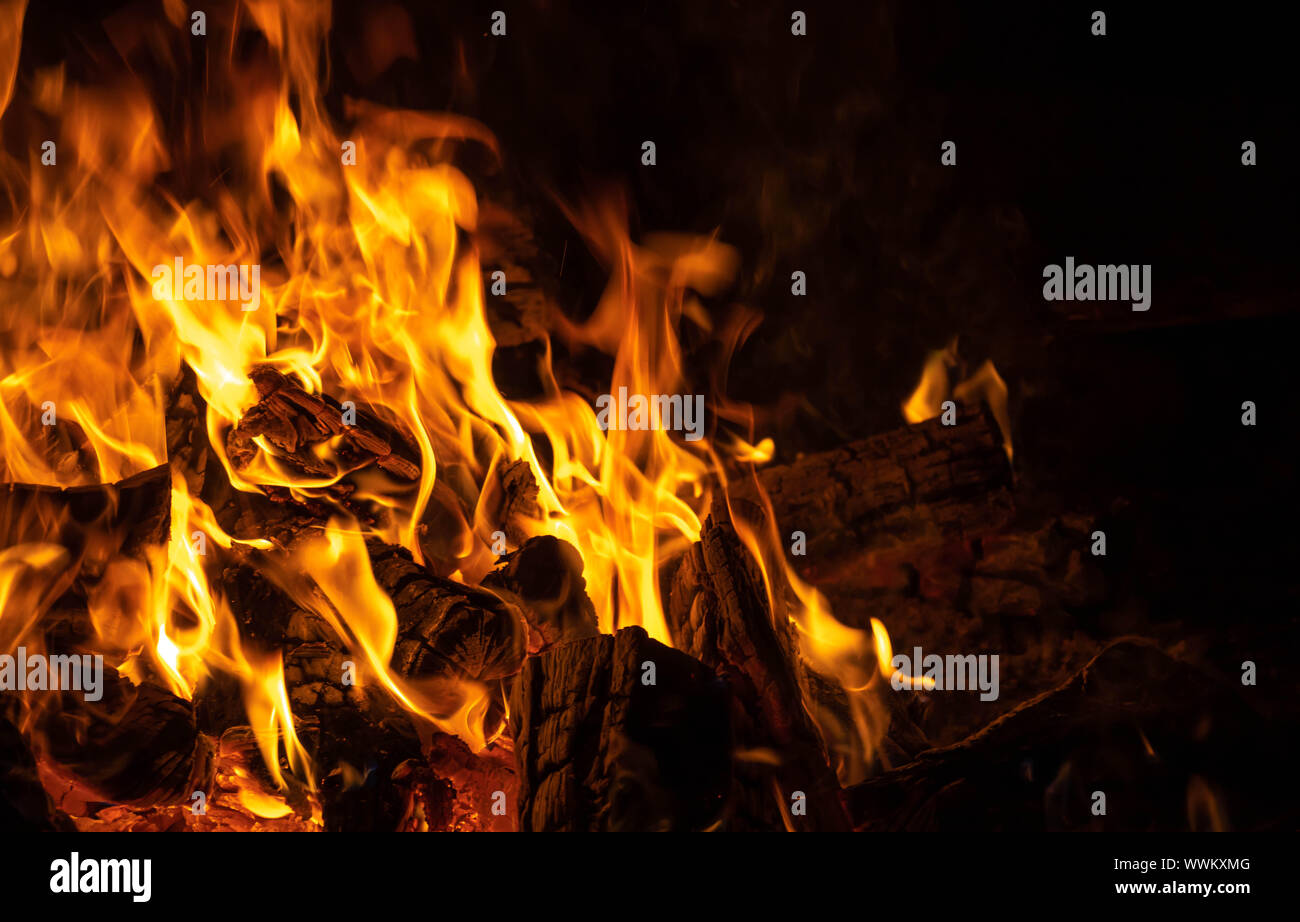 fireplace background burning wood on black Stock Photo - Alamy