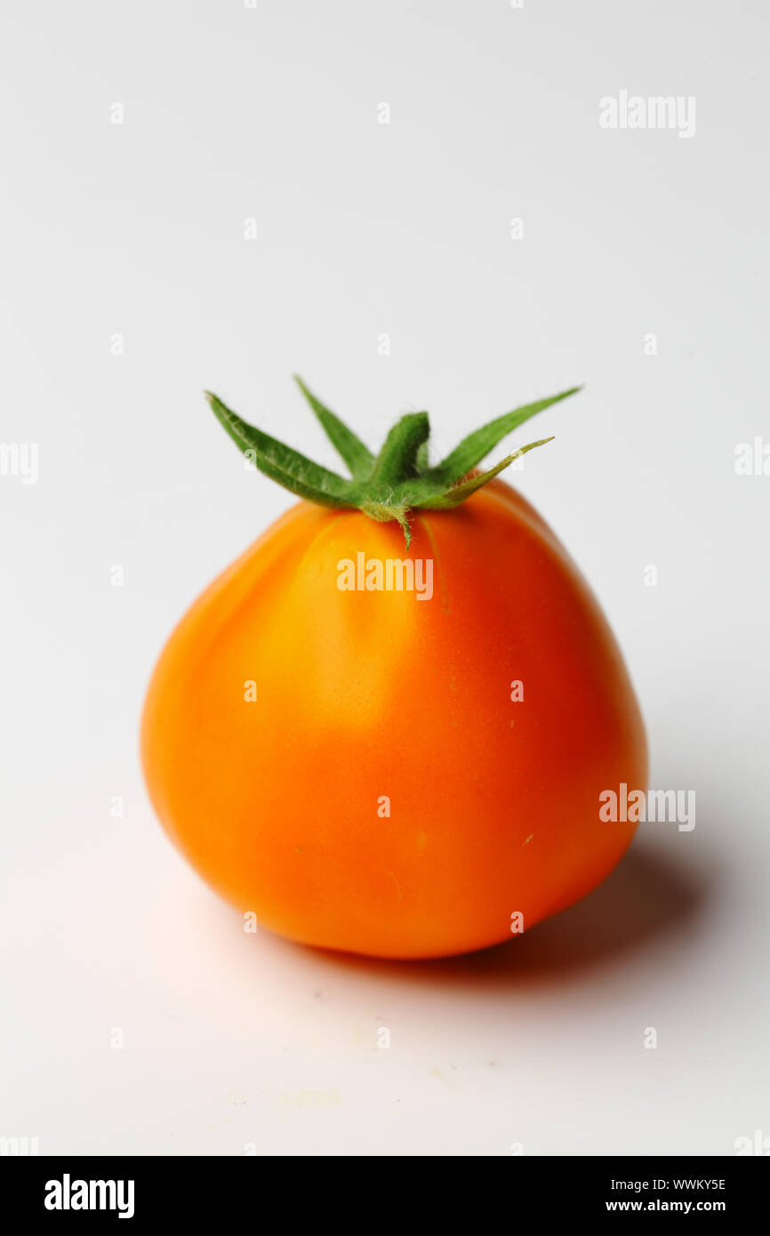 orange tomato isolated on white Stock Photo - Alamy