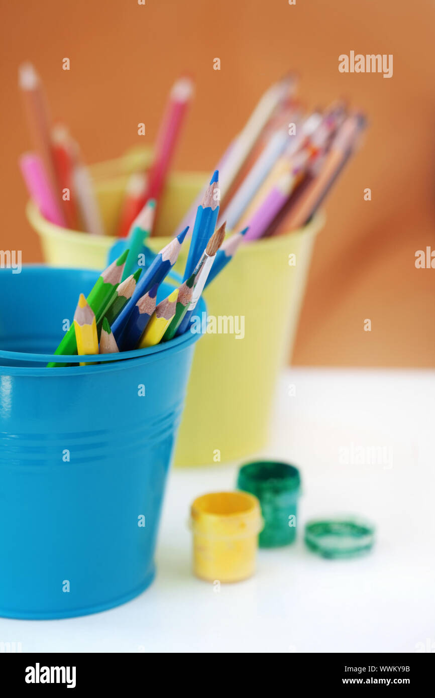 Colorful pencils in storage buckets Stock Photo - Alamy