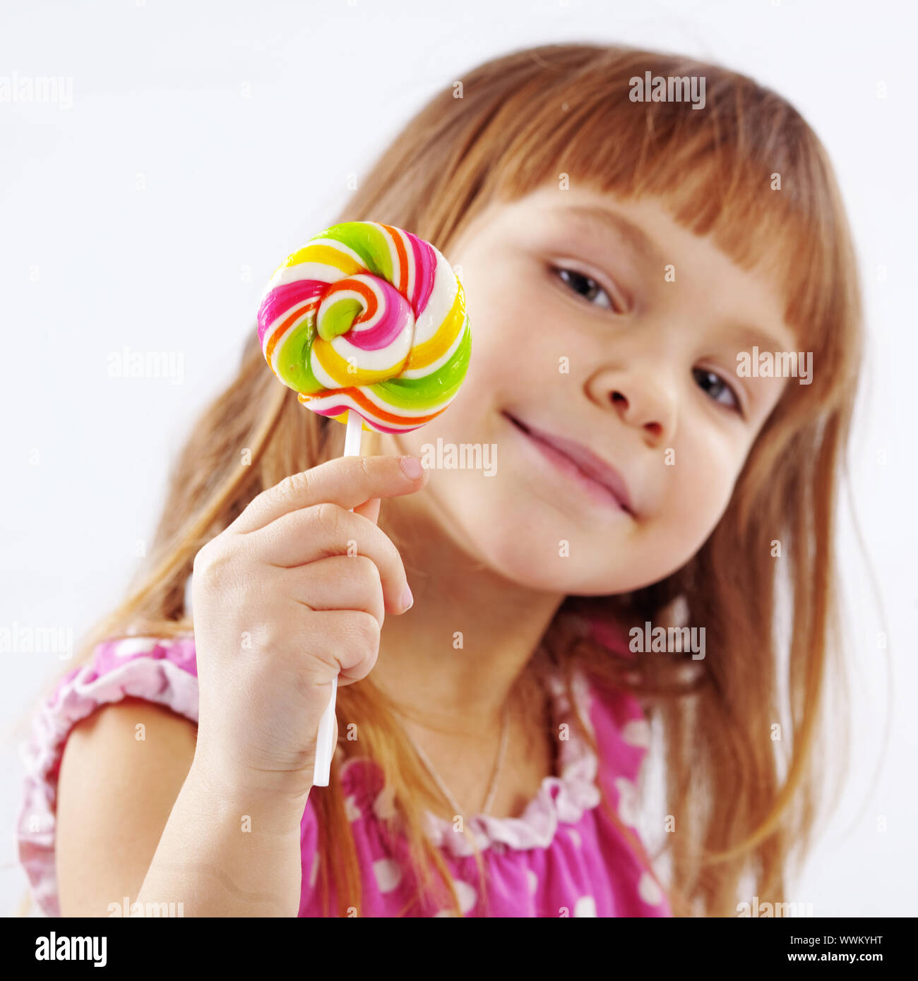Portrait of funny child eating sweet candy Stock Photo - Alamy
