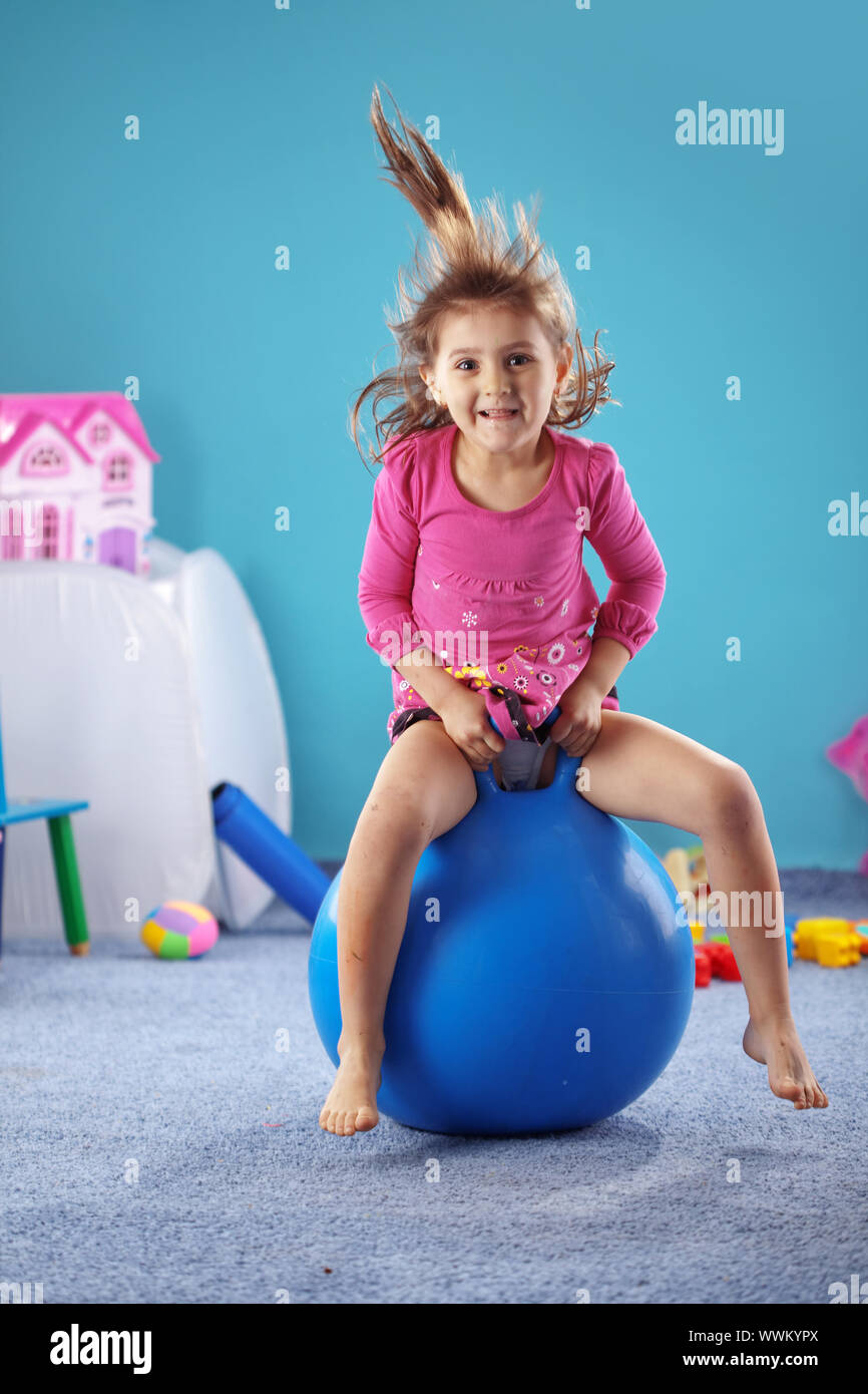 Child jumping on gymnastic ball Stock Photo - Alamy