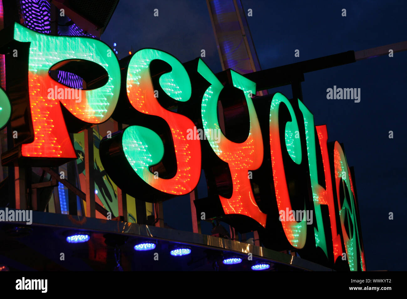 Neon fun fair attraction advertising at night Stock Photo - Alamy