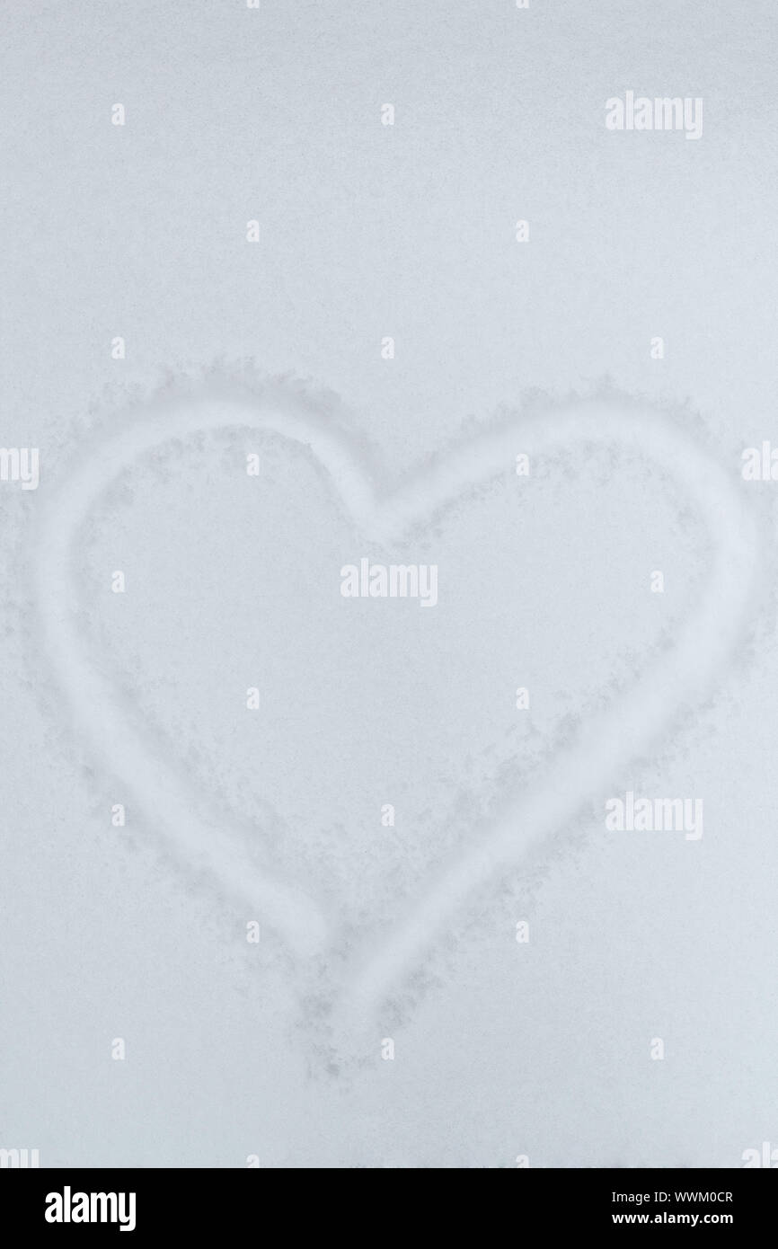 Heart drawn in the snow - a symbol of love Stock Photo - Alamy