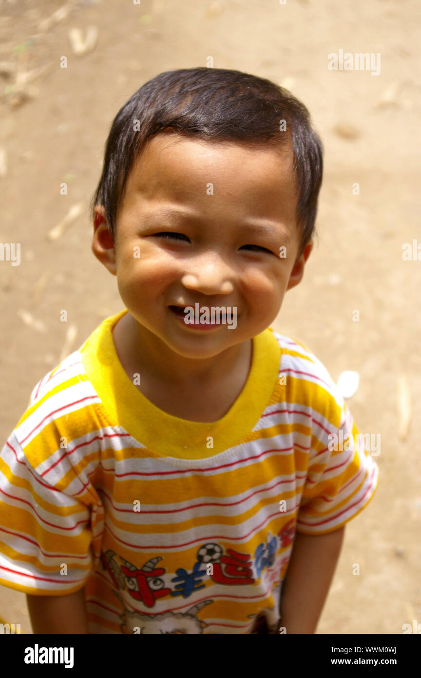 CHINA - MAY 17, A traditional Chinese young boy is smiling on Yangshuo ...