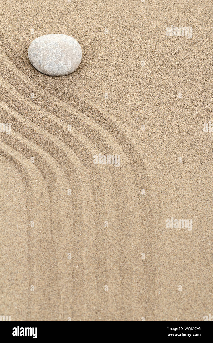 zen stone in sand Stock Photo - Alamy