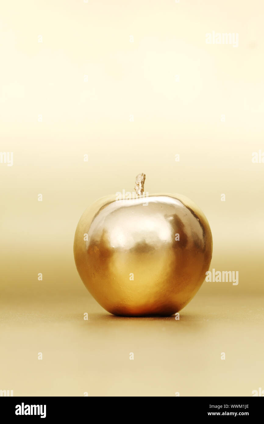 gold apple on gold background Stock Photo - Alamy