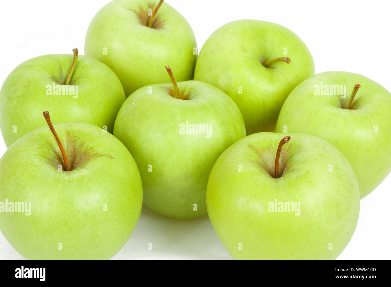 seven green apples isolated on a white background Stock Photo - Alamy