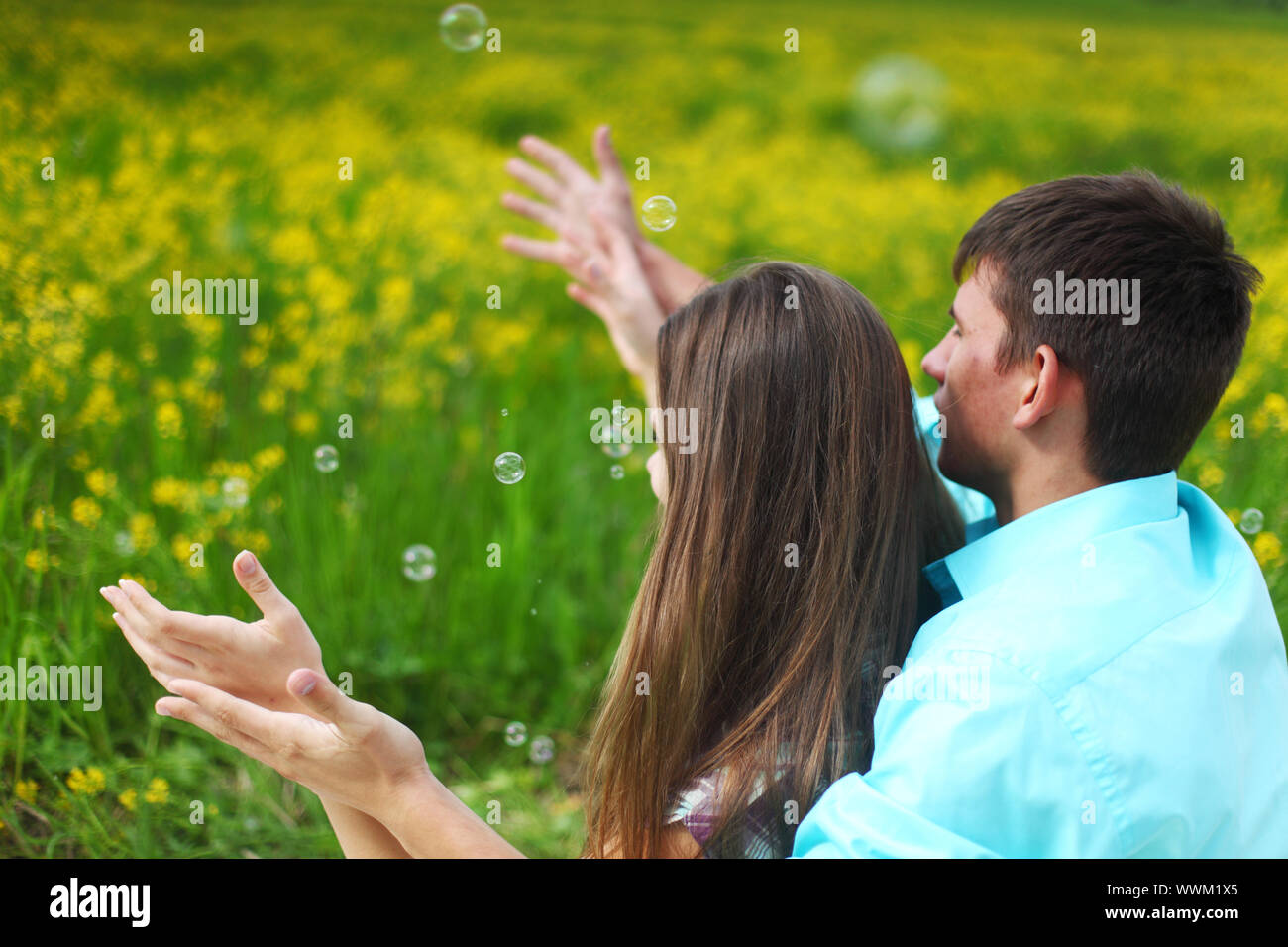 lovers hug on yellow flower field Stock Photo - Alamy
