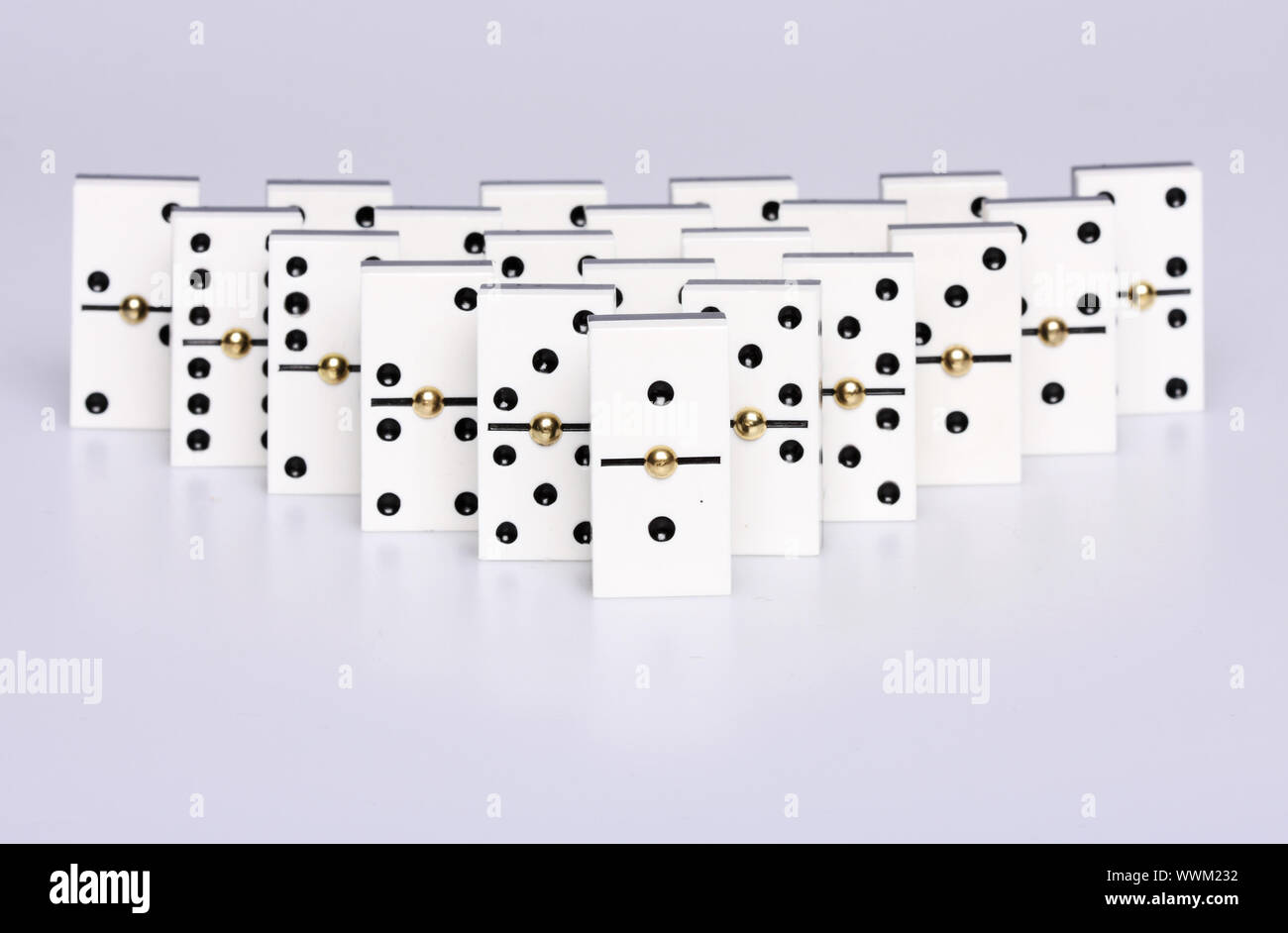 Dominos lined up ready to be pushed over Stock Photo - Alamy