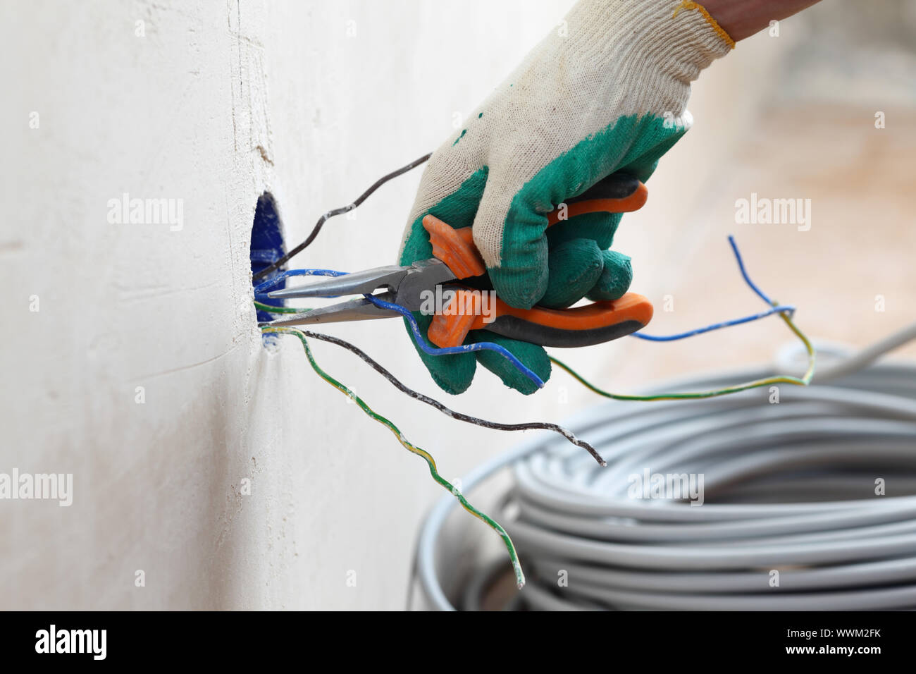 worker puts the wires in the wall Stock Photo - Alamy