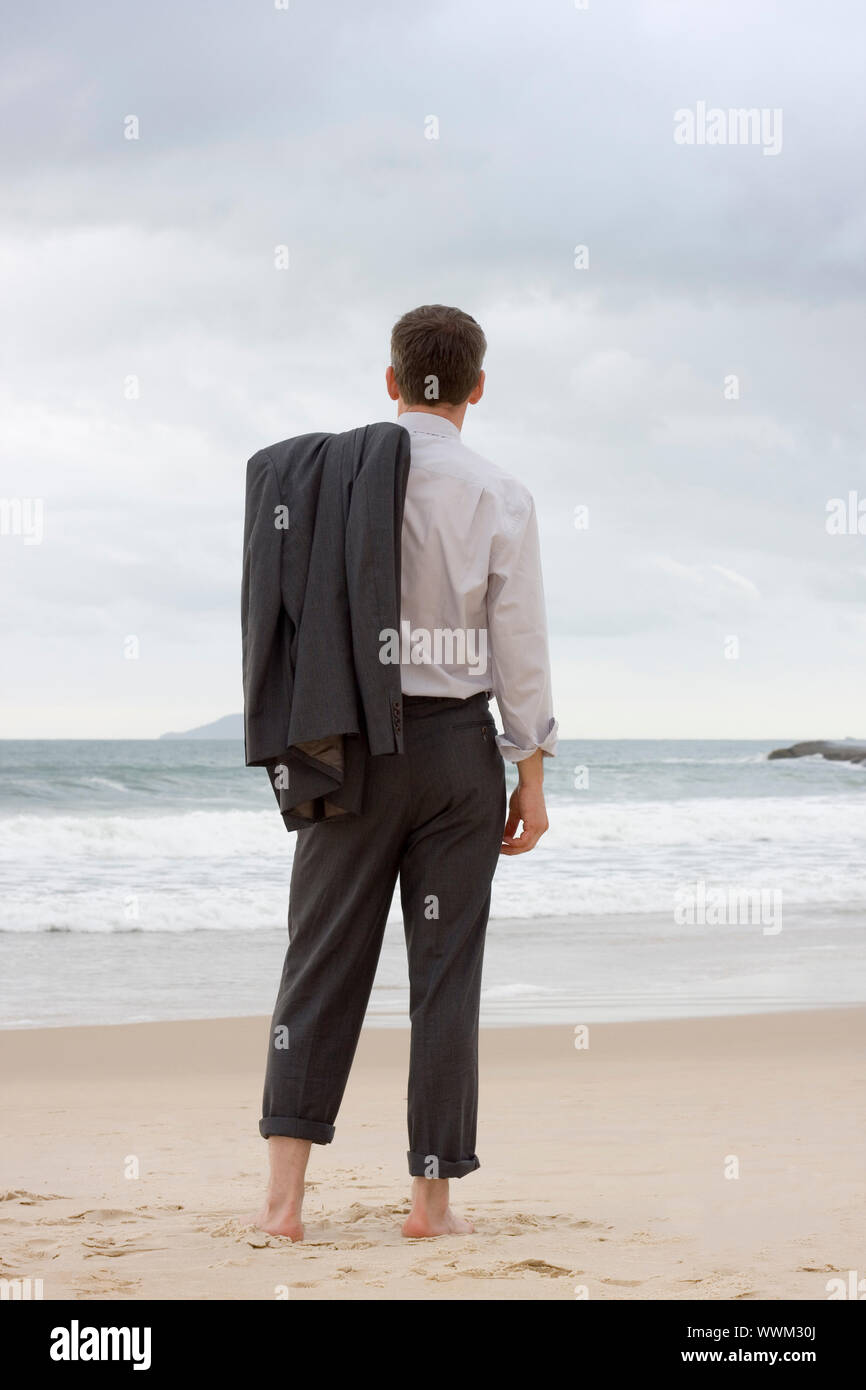 Barefoot businessman relaxing on a beach Stock Photo - Alamy