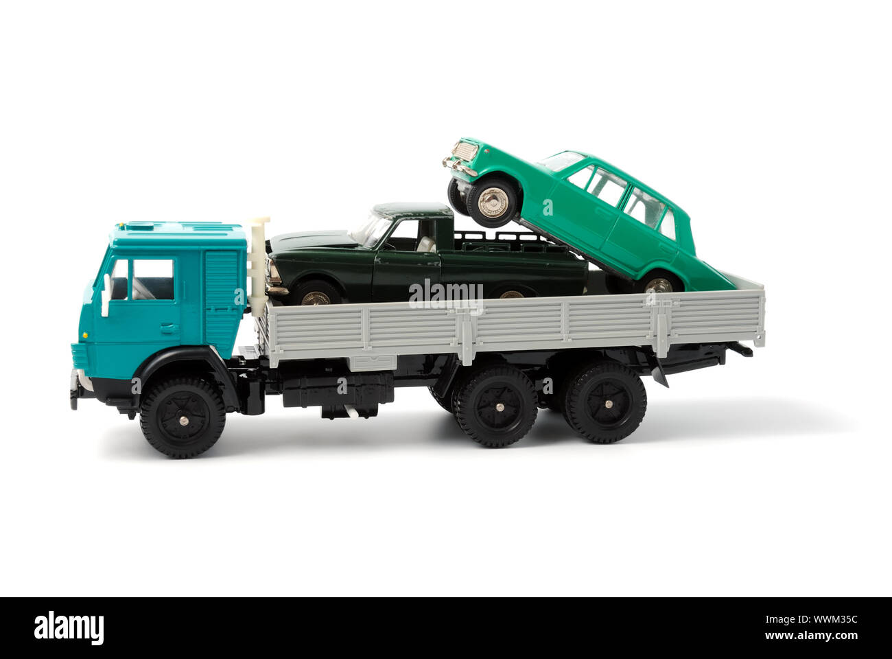 Toy cars in the back of toy truck on a white background Stock Photo - Alamy