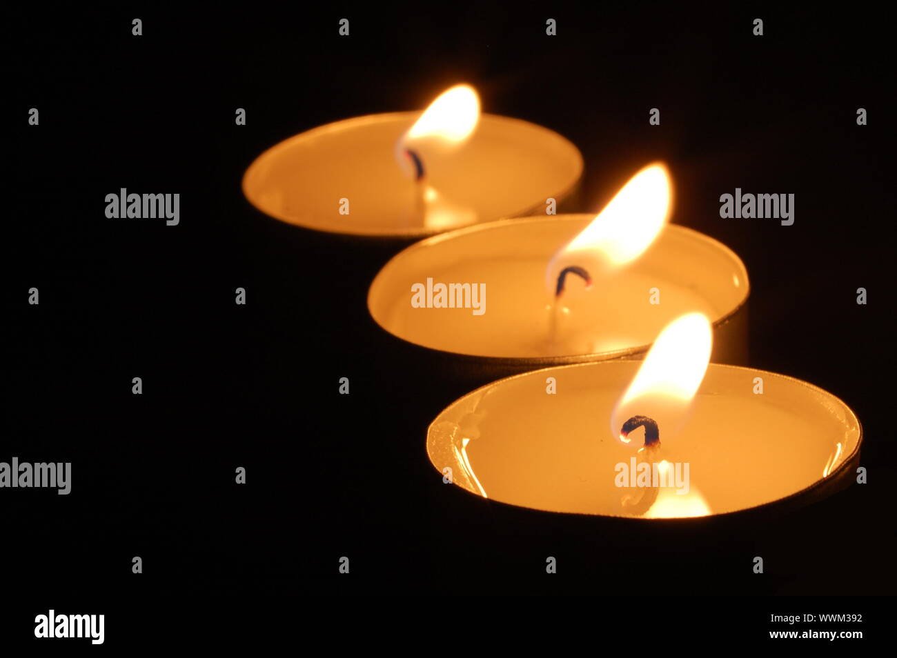 romantic hot candle light on black background Stock Photo - Alamy